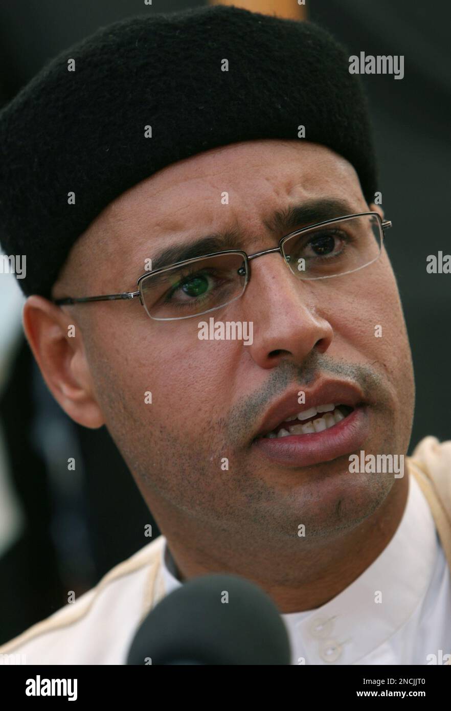 FILE - Seif al-Islam Gadhafi talks to reporters at the ancient city of ...