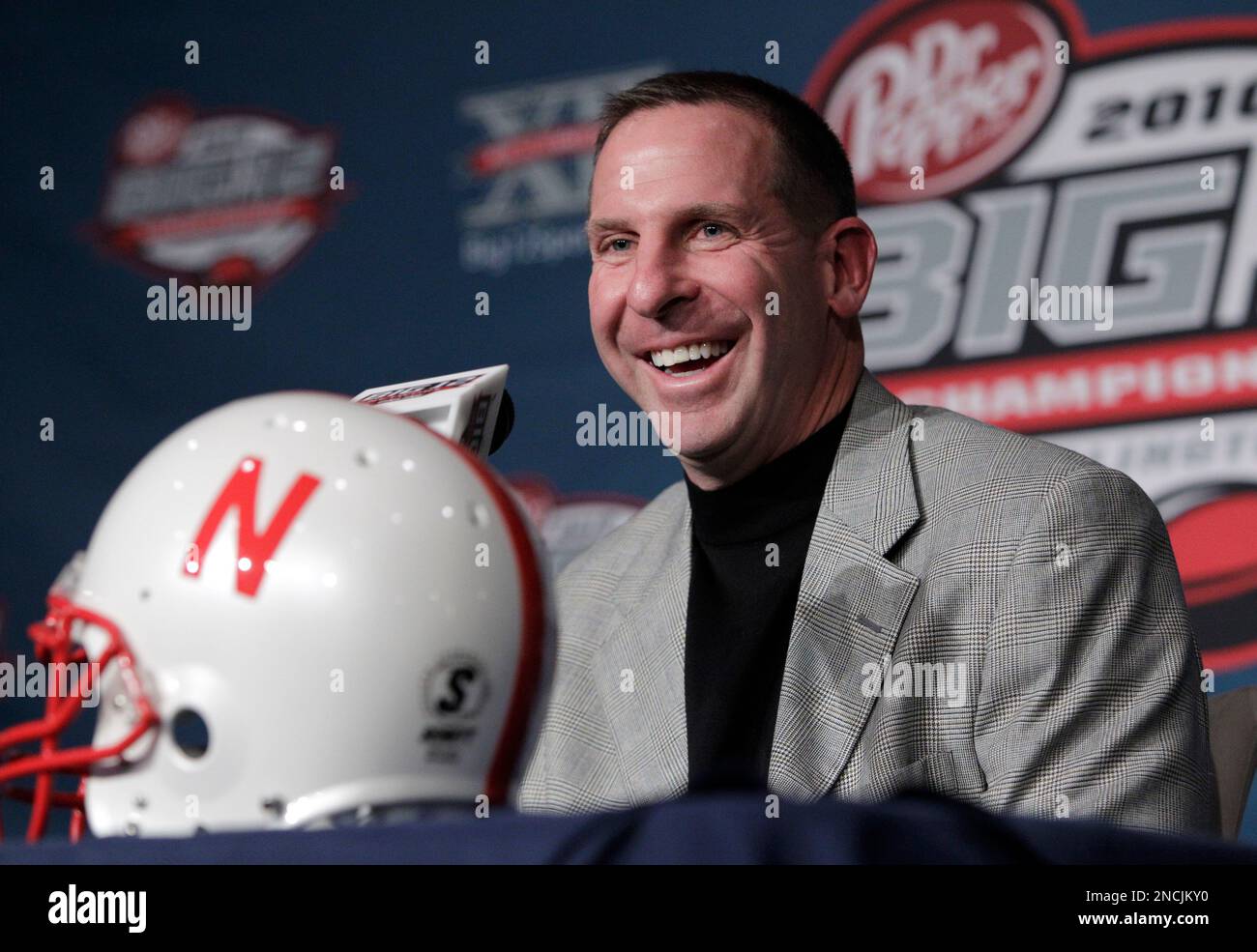 Nebraska coach Bo Pelini laughs as he responds to a question during a ...