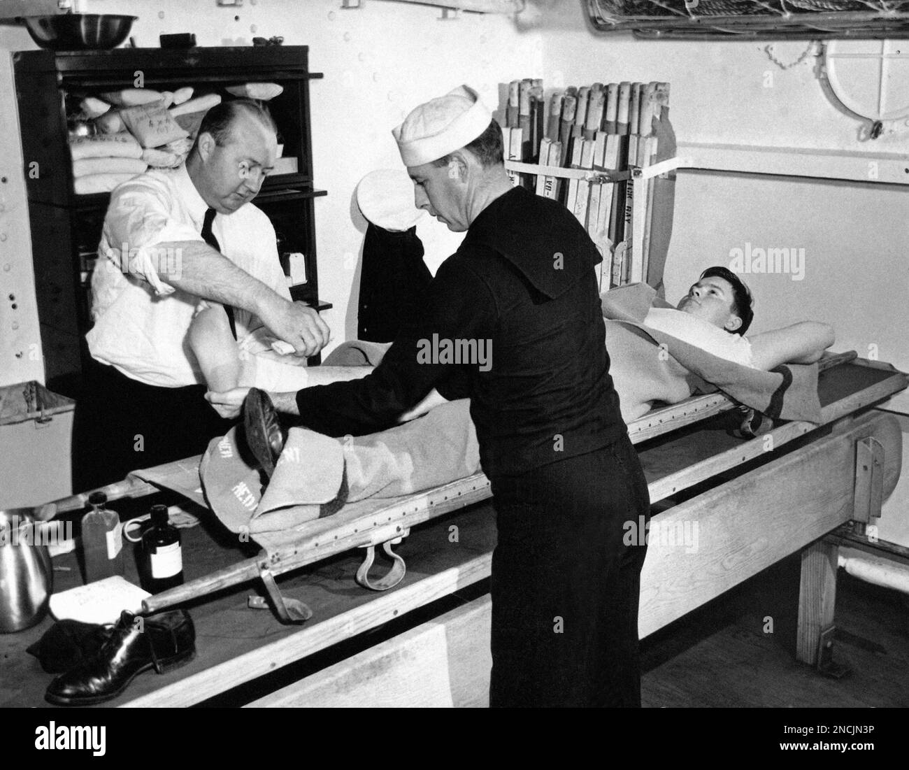 U.S. Navy doctor, left, and a chief Pharmacists mate work in a ...