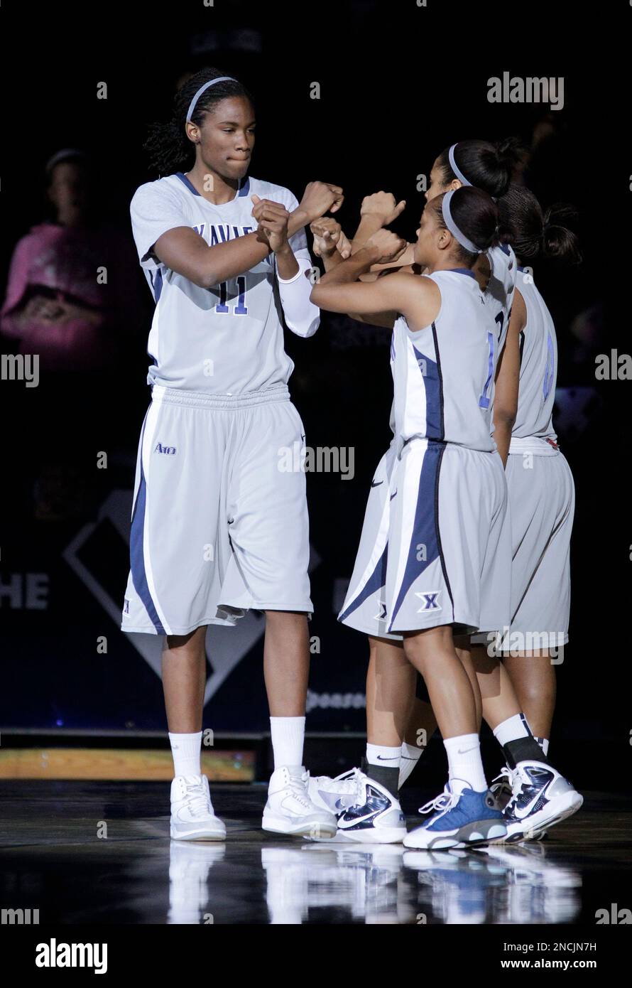 Xavier forward Amber Harris, left, is introduced prior to an NCAA ...