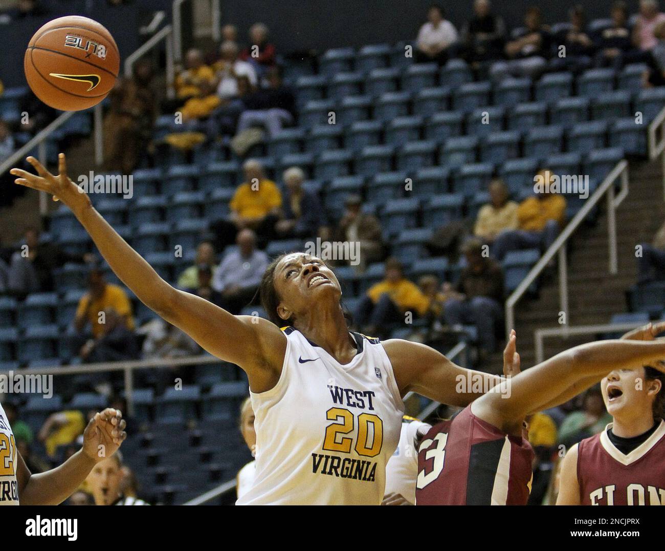 West Virginia's Asya Bussie (20) reaches for a rebound in the first ...