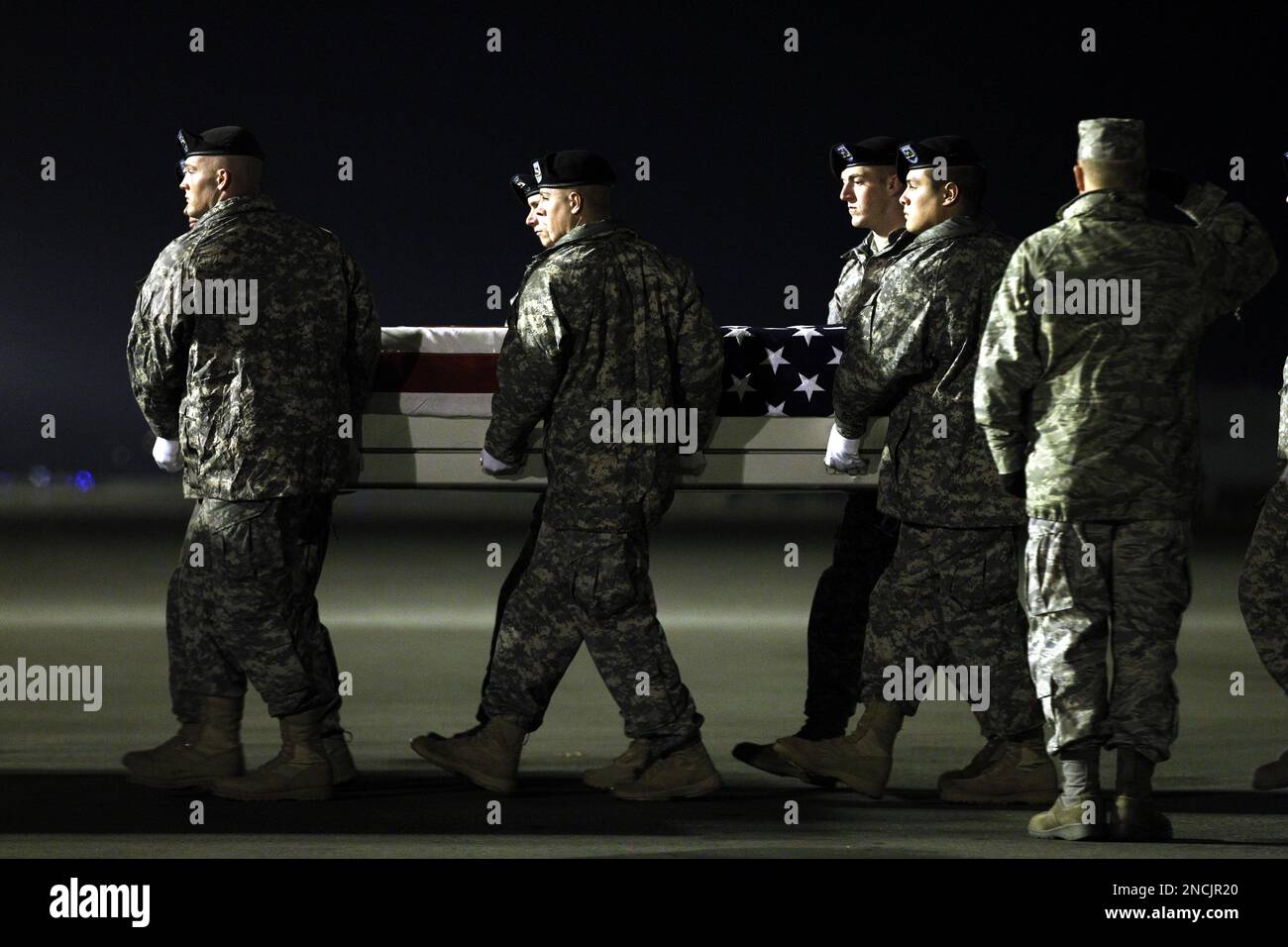 An Army carry team carries the transfer case containing the remains of ...