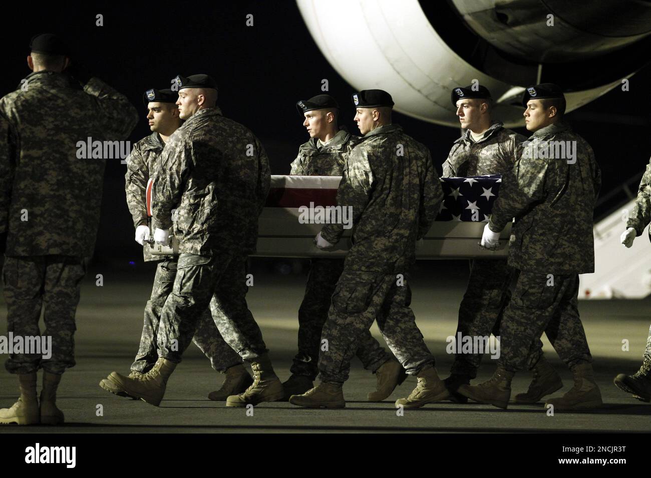 An Army carry team carries the transfer case containing the remains of ...