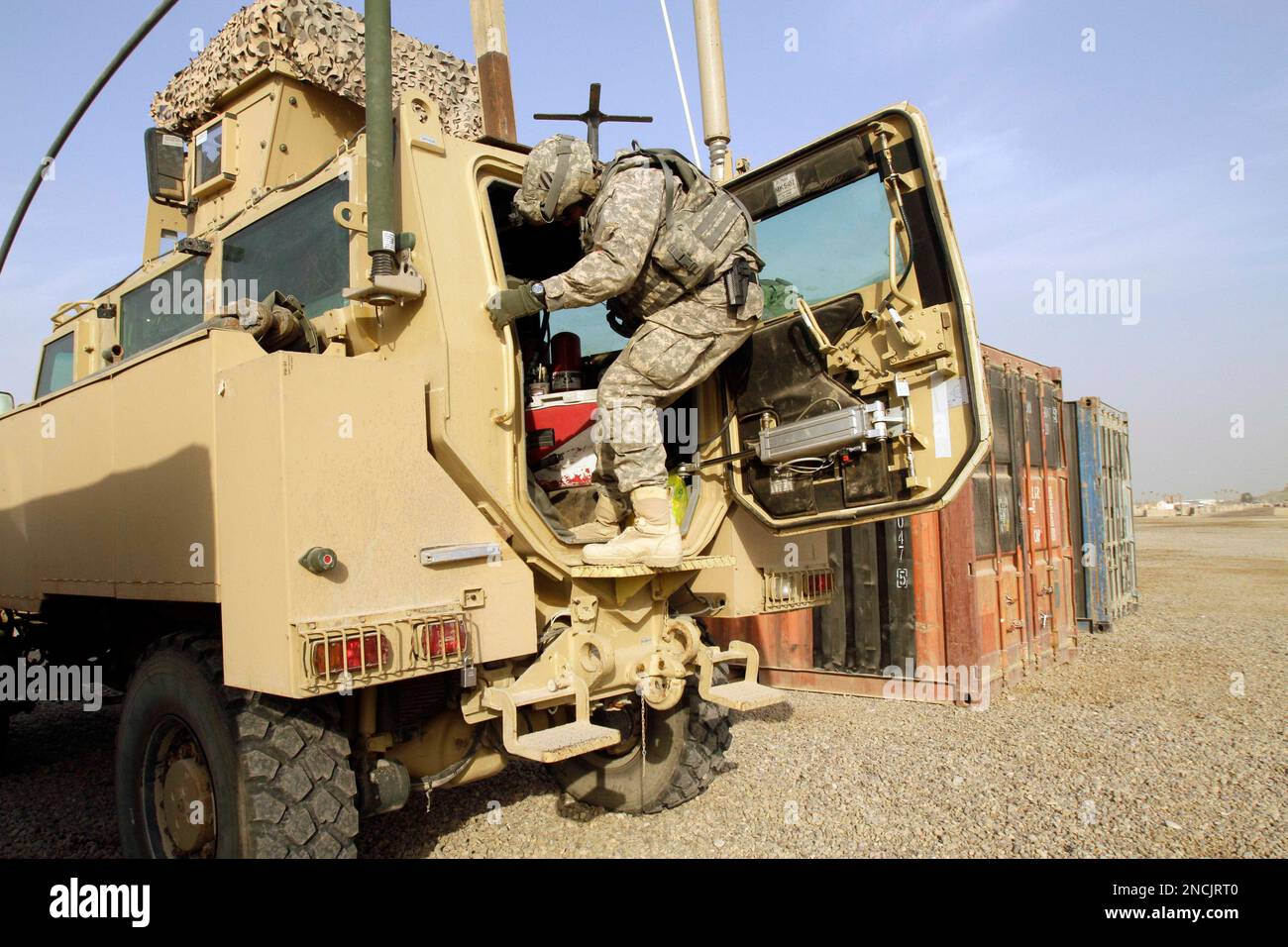 U.S. Army Maj. David Rozelle climbs into an MRAP (Mine Resistant Ambush ...