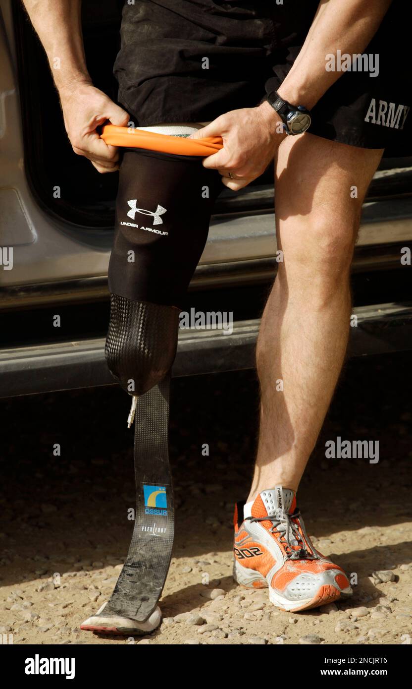 U.S. Army Maj. David Rozelle puts on a specialized prosthetic leg ...