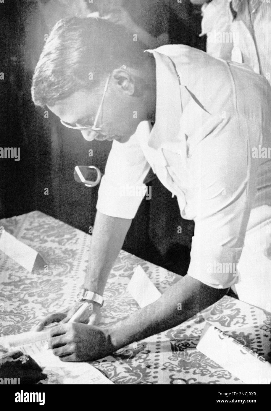 Bangladesh President Ziaur Rahman signs his allot before voting in ...