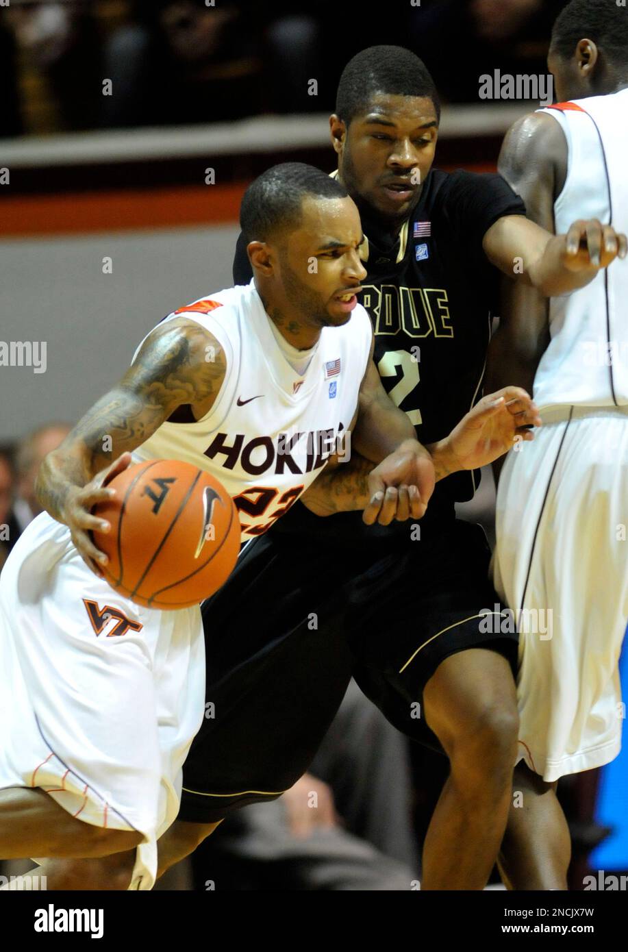 Purdue's Kelsy Barlow, center, defends Virginia Tech's Malcolm Delaney ...