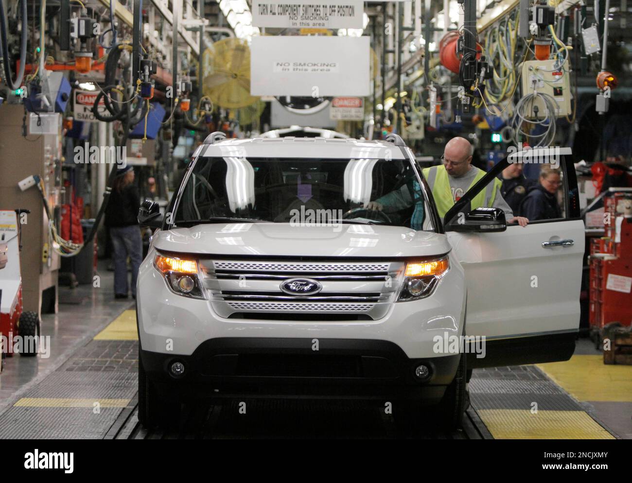 Plant employees assemble a 2011 Ford Explorer am the assembly line at ...