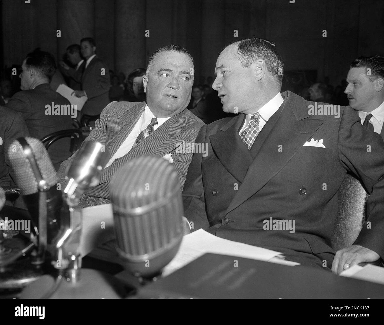 Sitting side by side communication microphone authority Black and White ...