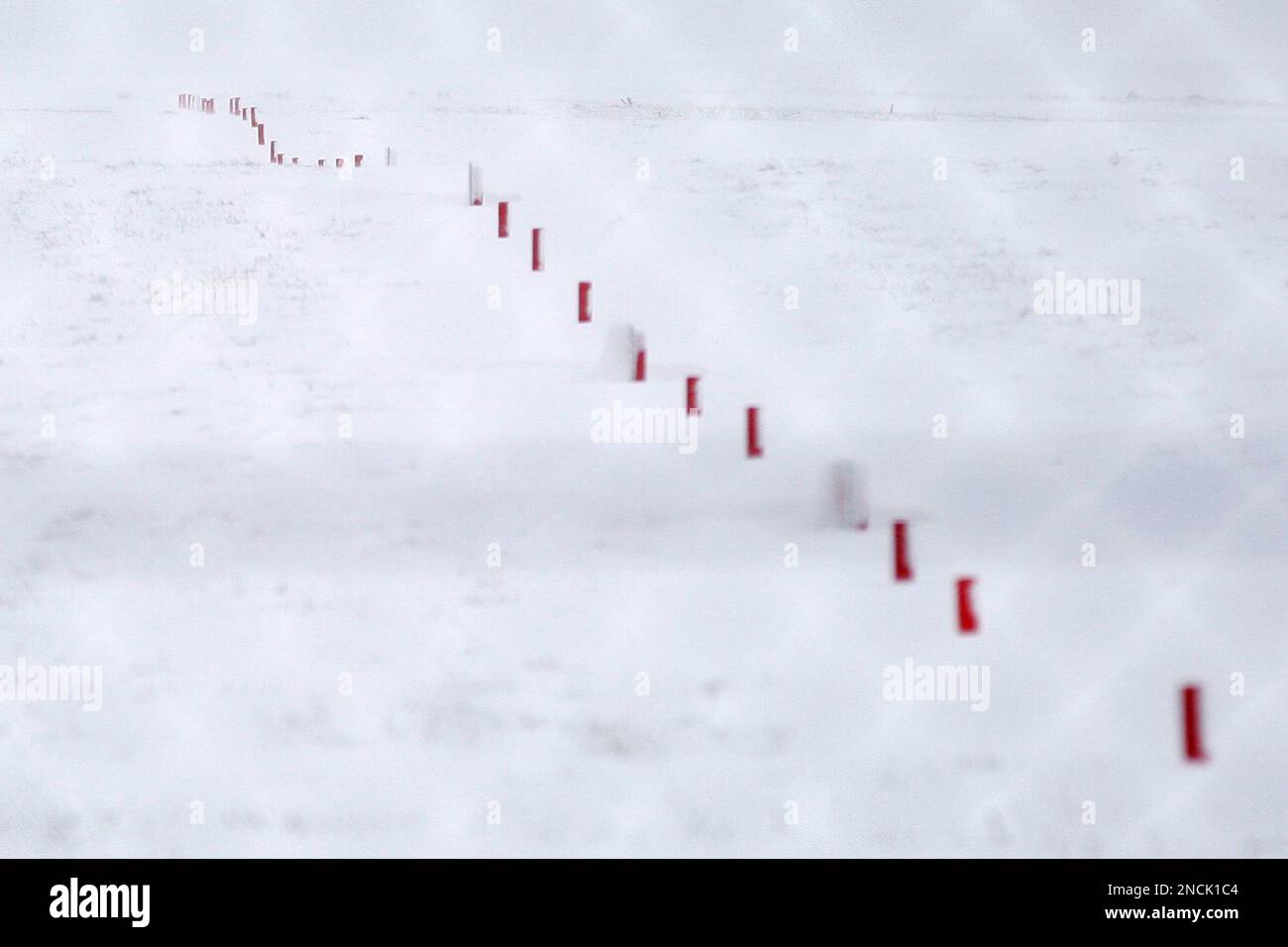 Edge markers are seen on a snow covered runway at London Gatwick ...