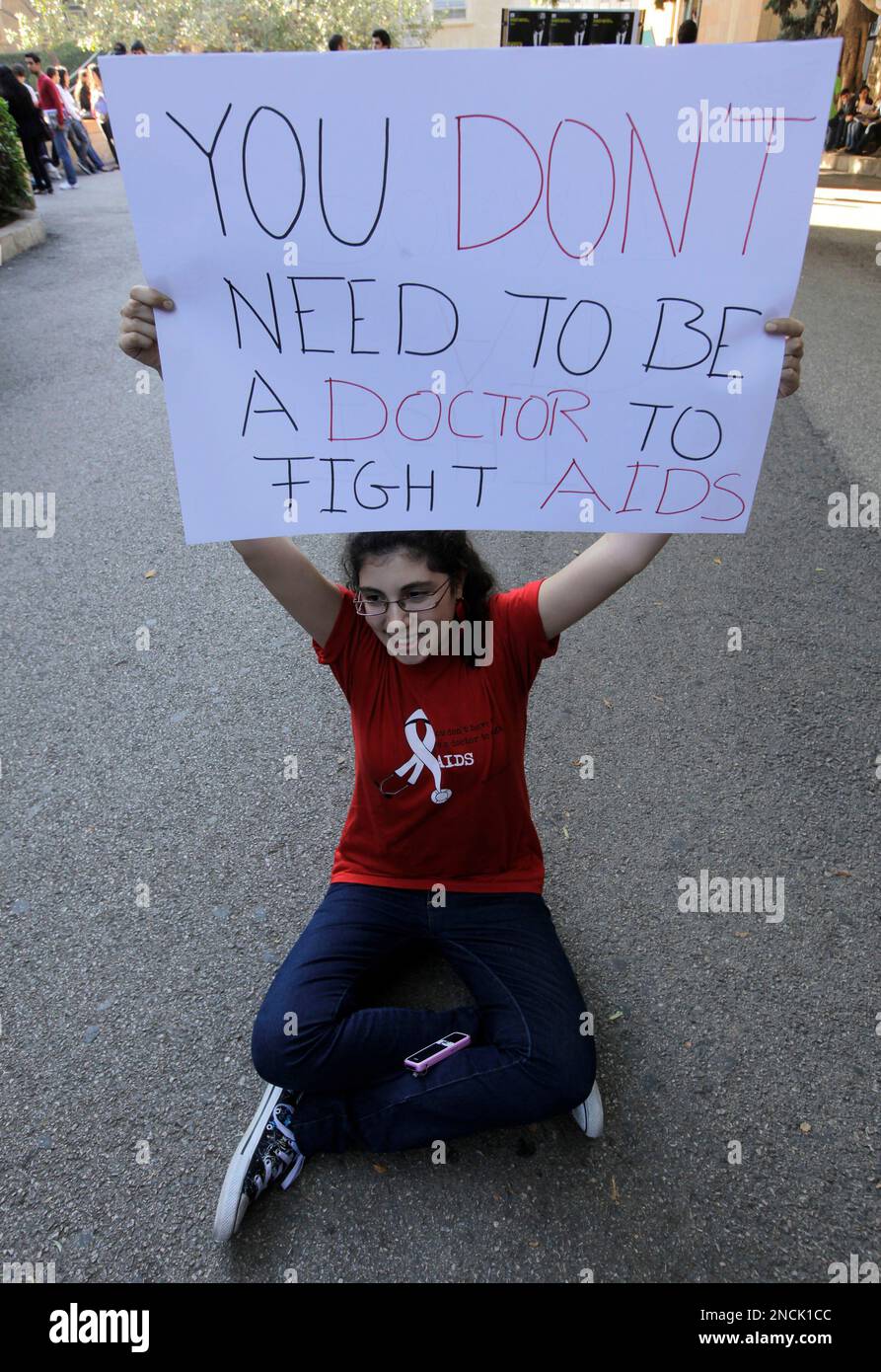 A student carries a banner during the "Free Hugs: Hugging is really not ...