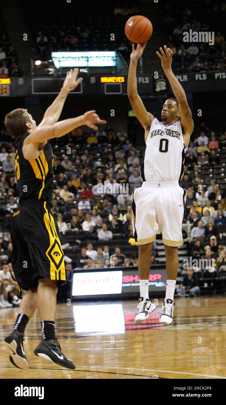 Wake Forest's J.T. Terrell (0) shoots over Iowa's Eric May (25) in the ...