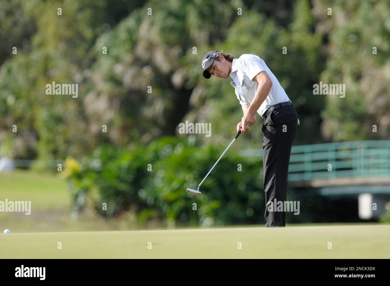 Aaron Baddeley, of Australia, watches his putt on the 18th green during ...