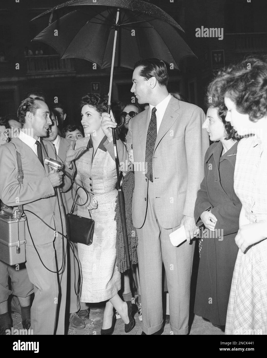 Glamorous Gina Lollobrigida answers the questions of a radio reporter ...