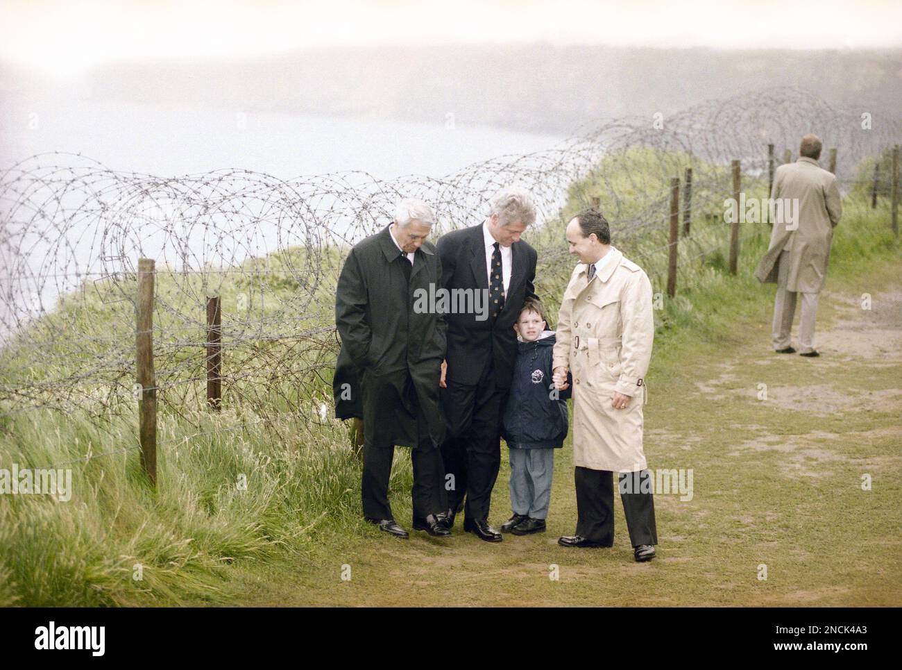 U.S. President Bill Clinton walks with Ken Bargmann, left, who, as an ...