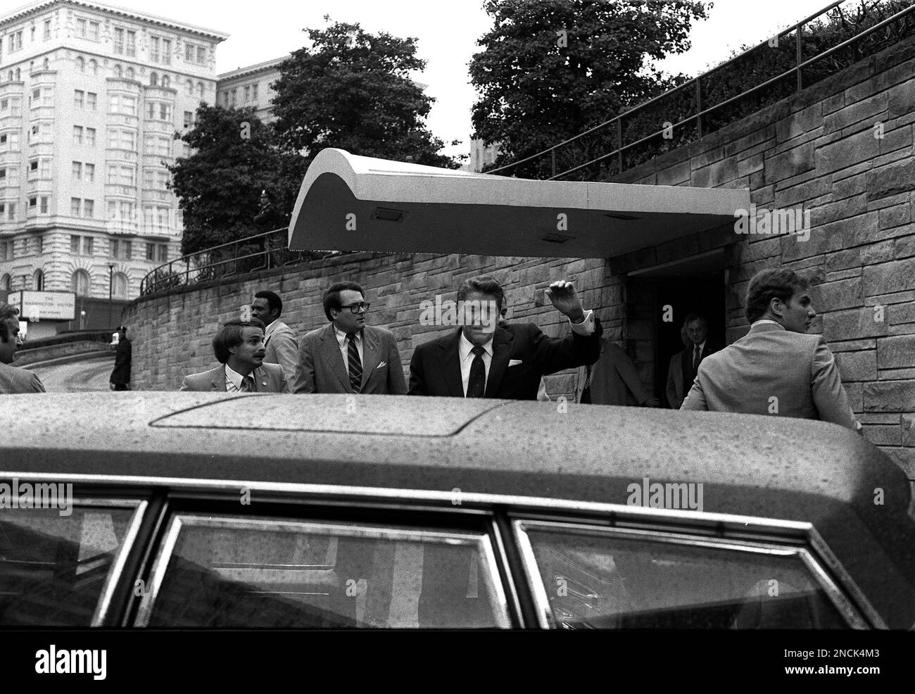 U.S. President Ronald Reagan being shoved into the President's ...