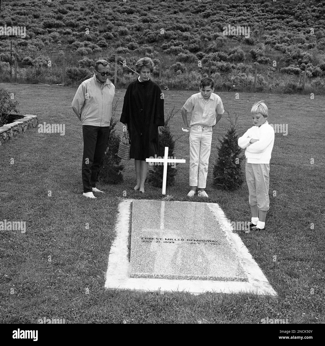 Tourists look at the marble slab that marks the grave of Author Ernest ...