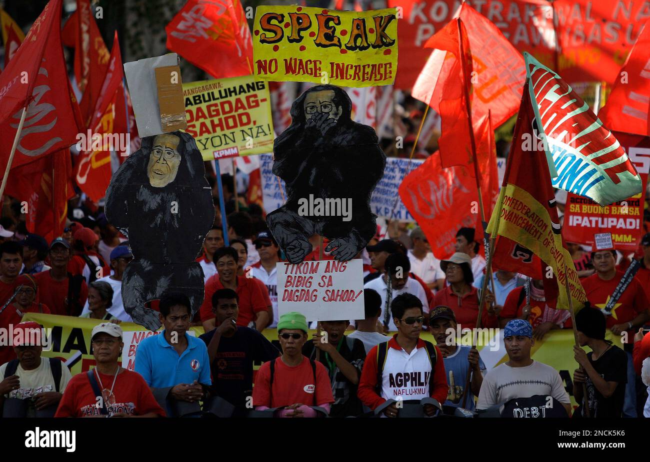 Filipino protesters carry caricatures of a monkey bearing the face of ...
