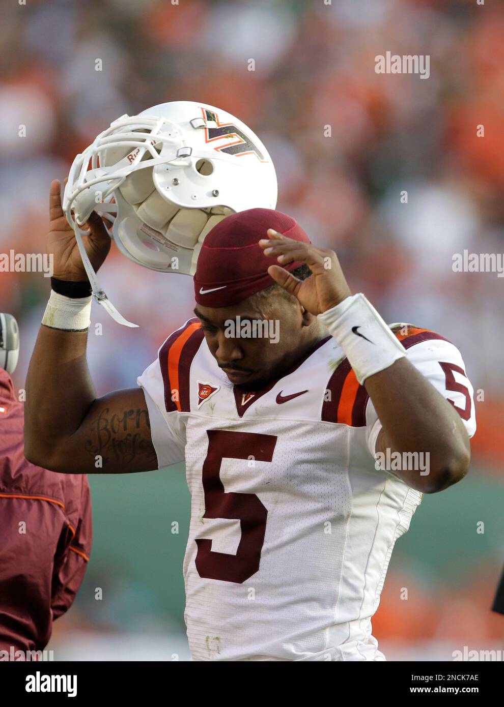 Virginia Tech quarterback Tyrod Taylor (5) takes off his helmet during ...