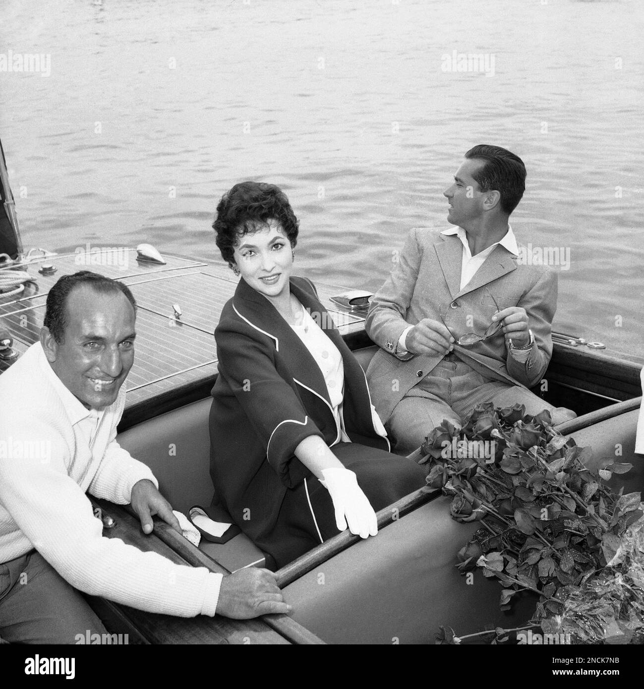 Italian screen actress Gina Lollobrigida sits in launch in the harbor ...