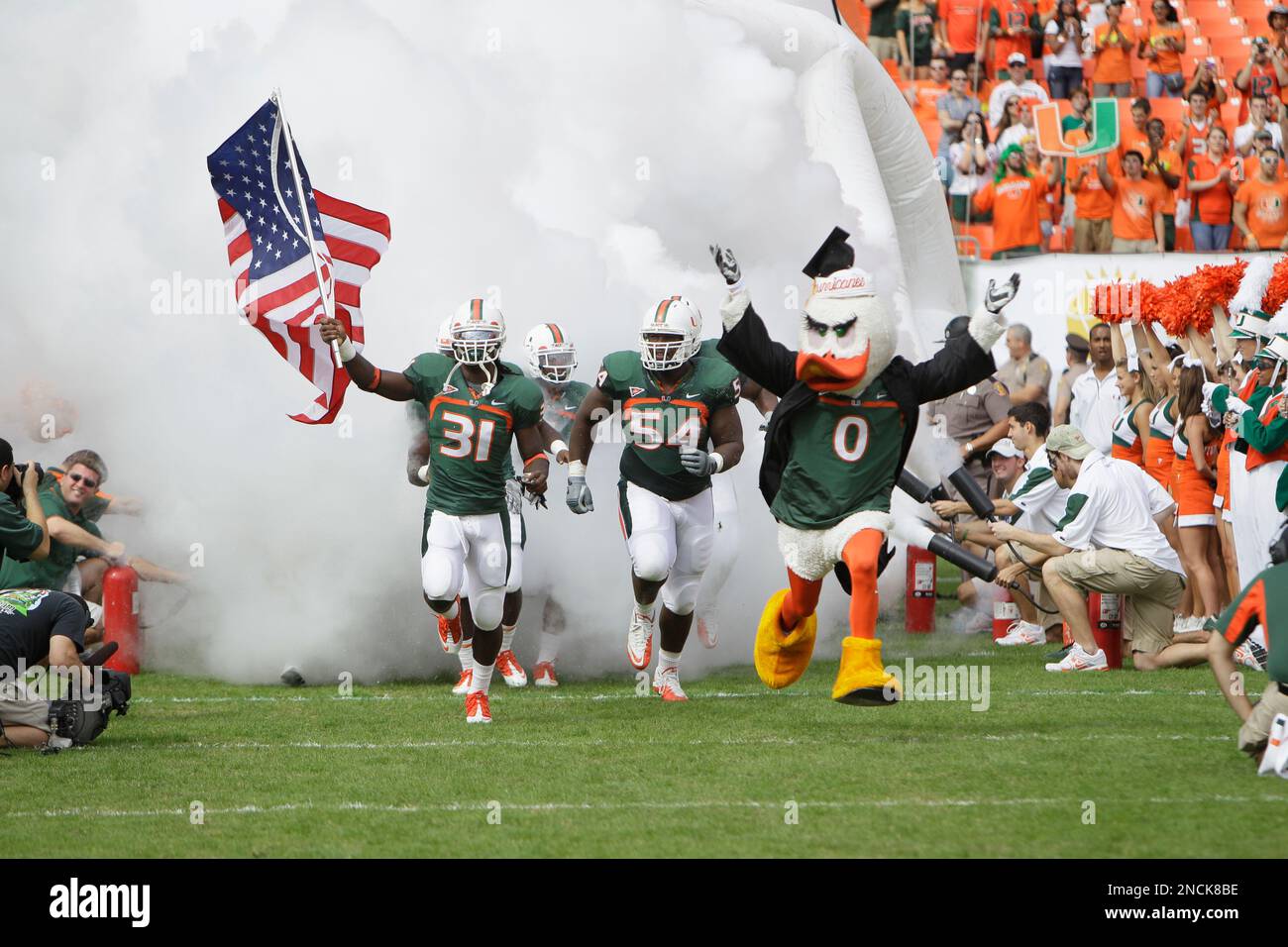 The University of Miami mascot and players come on the field during the ...