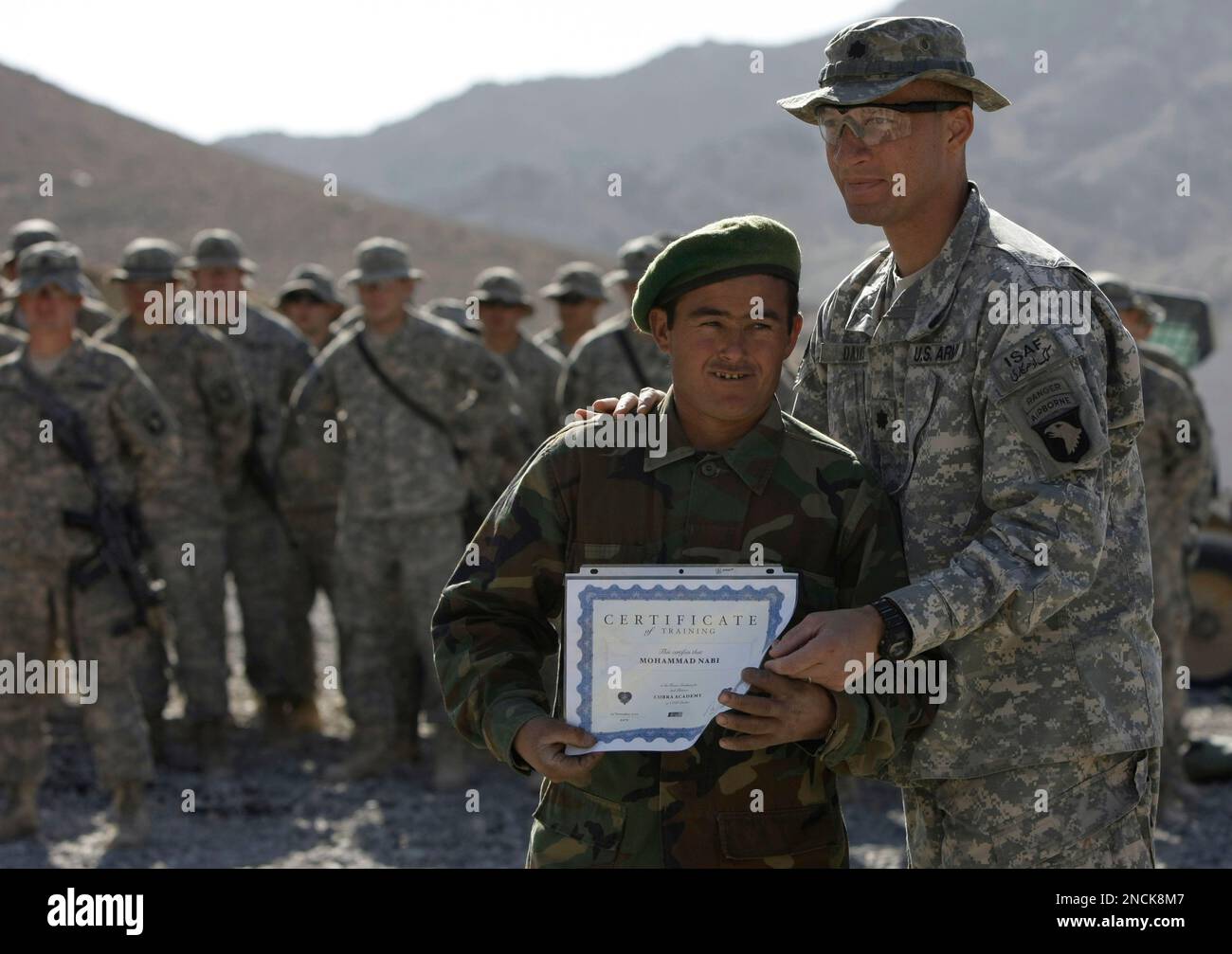 US Army Lt. Col. Johnny K. Davis, of Wisc., right, congratulates Afghan ...