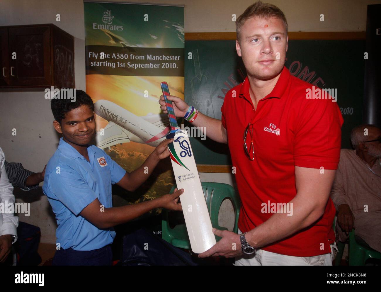 Former England cricket captain Andrew Flintoff, right, gives a bat to a ...