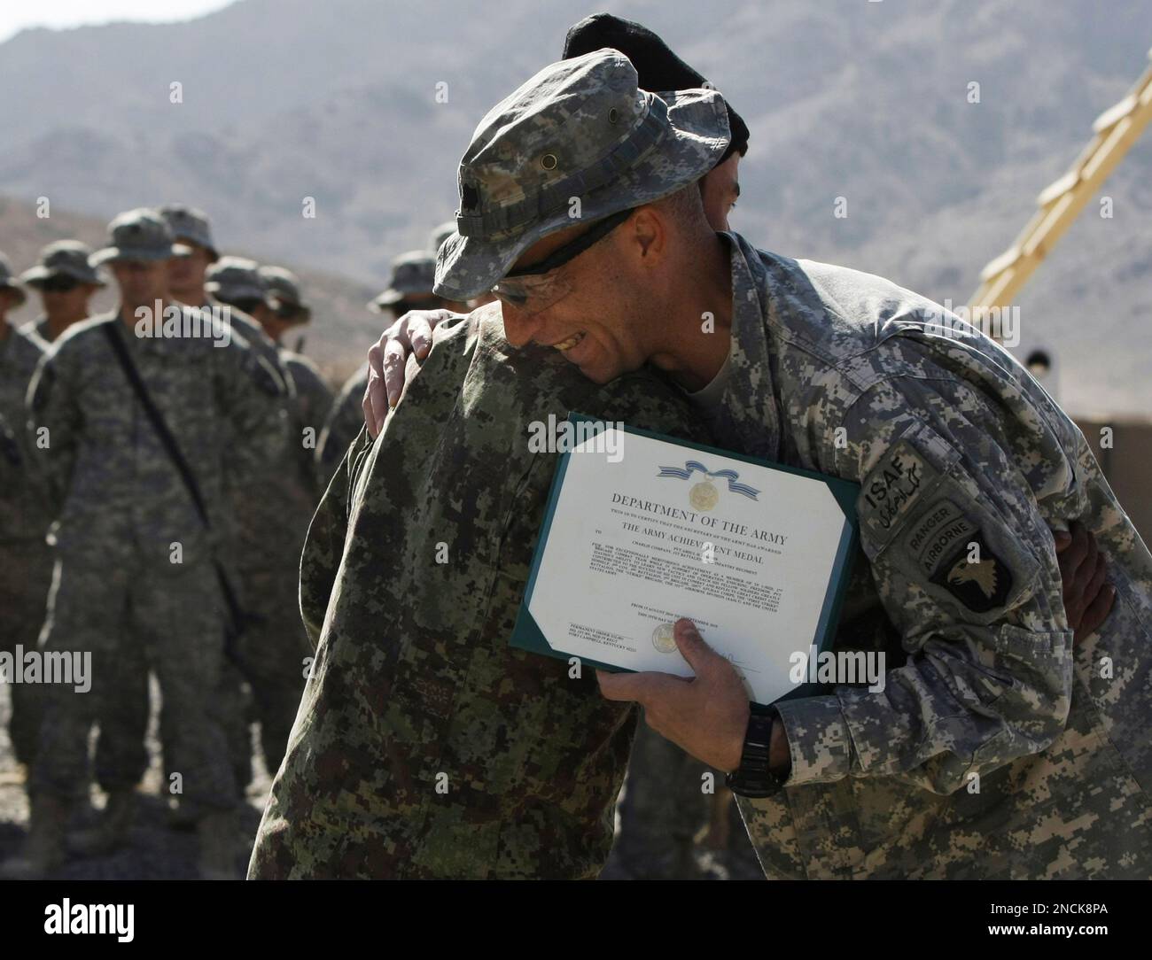 US Army Lt. Col. Johnny K. Davis, of Wisc., right, hugs Afghan national ...