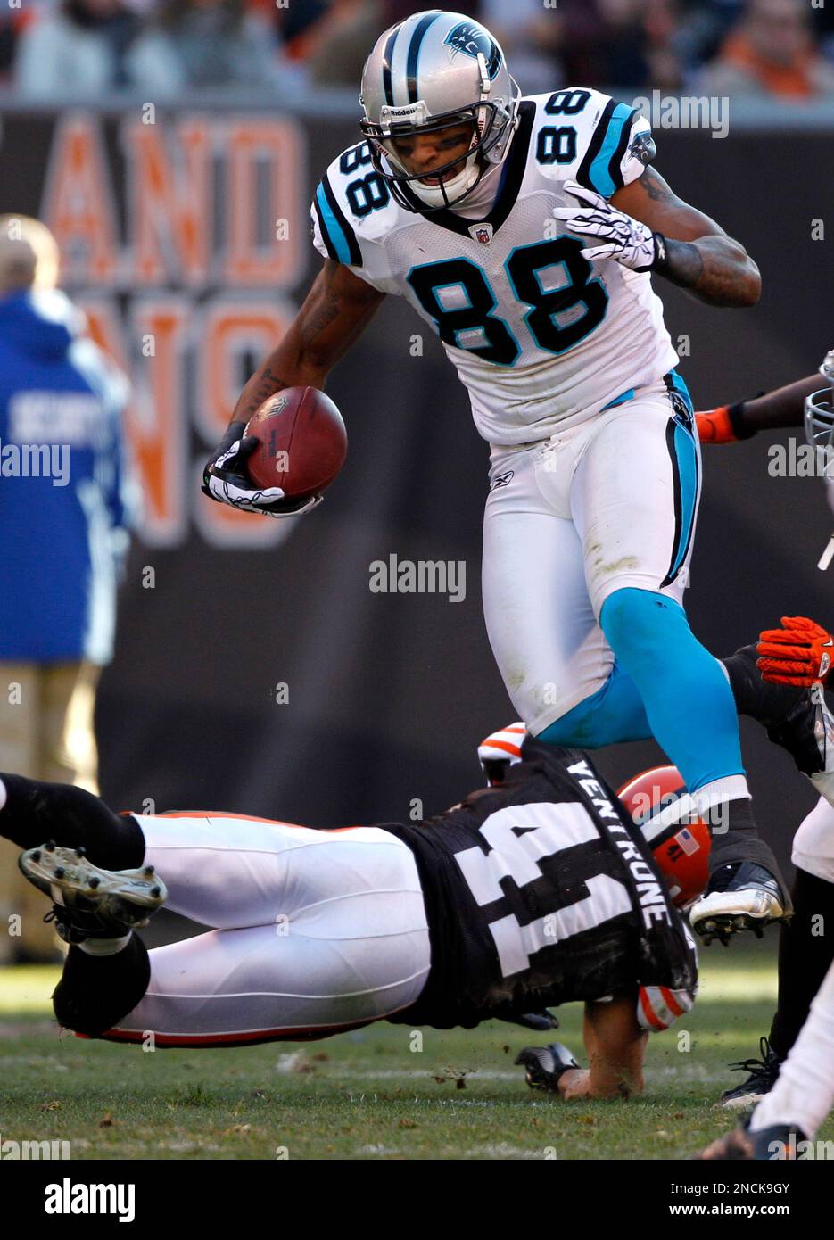 Carolina Panthers tight end Dante Rosario (88) leaps over a diving ...