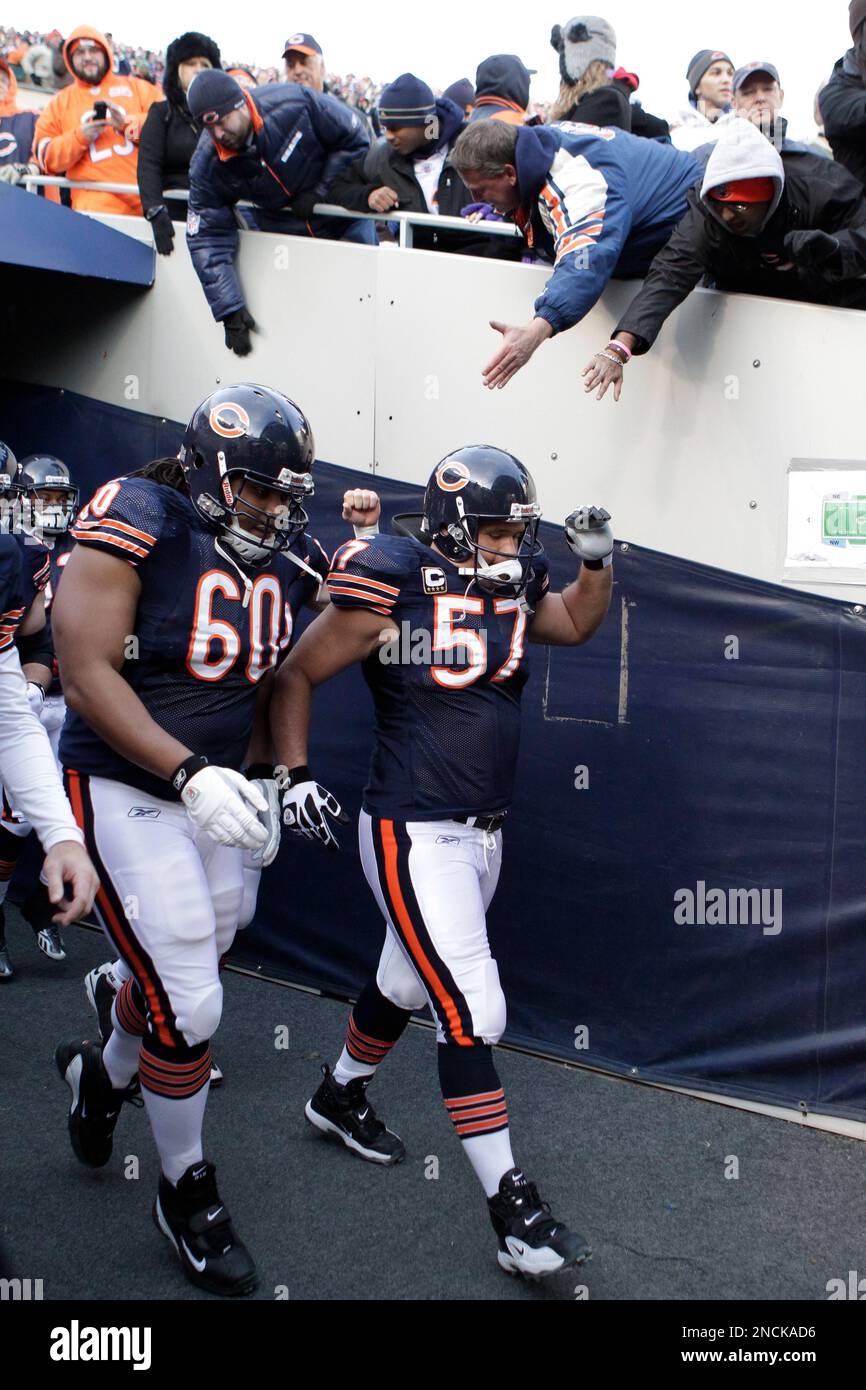 Chicago Bears' Lance Louis (60) and Olin Kreutz(57) run to the field ...