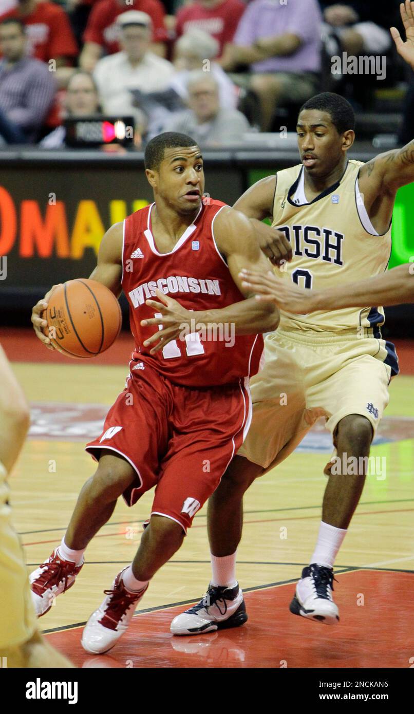 Wisconsin's Jordan Taylor, left, drives around Notre Dame's Eric Atkins during the first half of ...