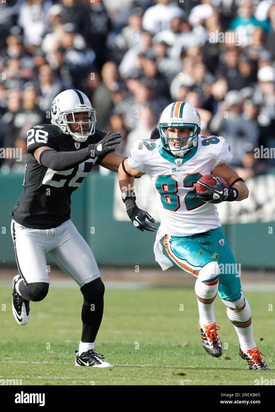 Miami Dolphins wide receiver Brian Hartline (82) and Oakland Raiders ...