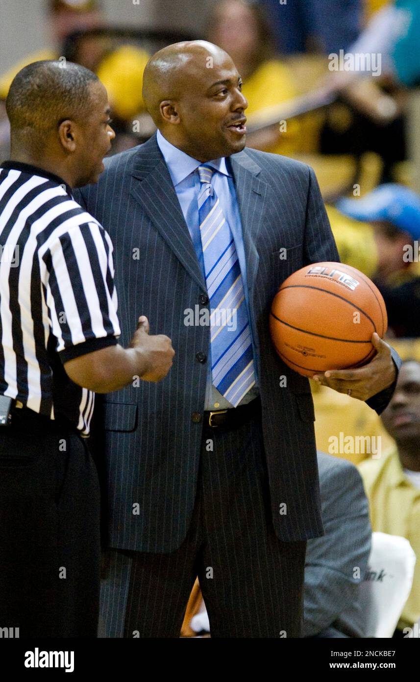 Arkansas Pine-Bluff head coach George Ivory, right, holds the ball ...