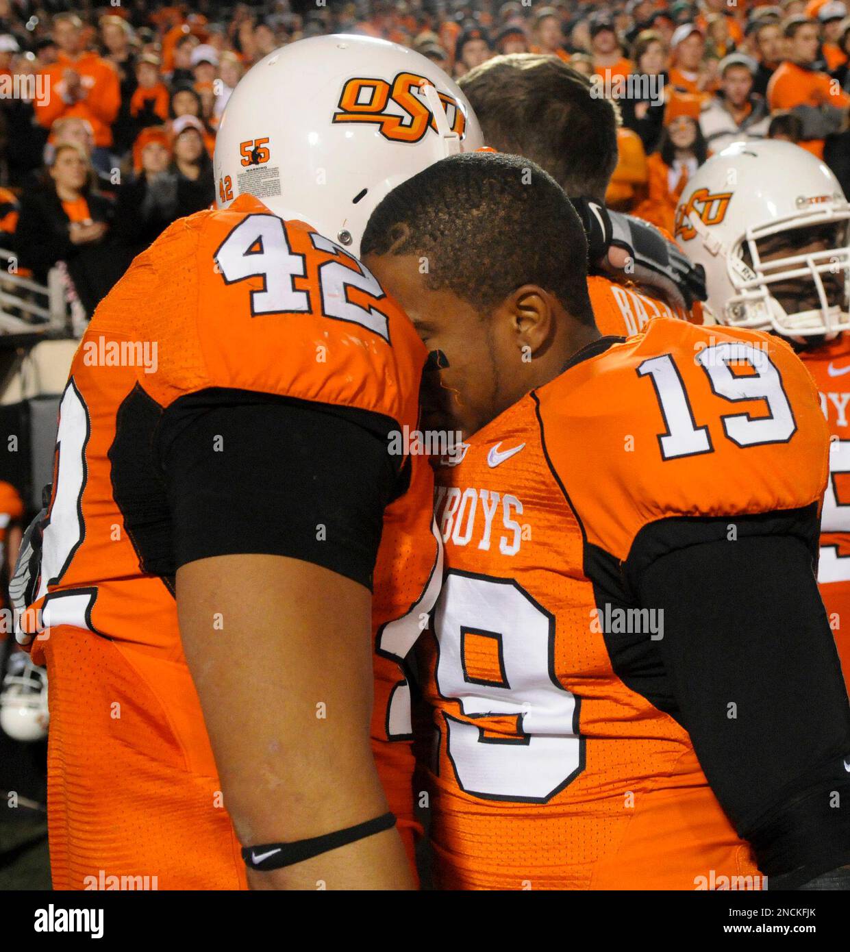 Oklahoma State's Brodrick Brown (19) buries his head into teammate ...