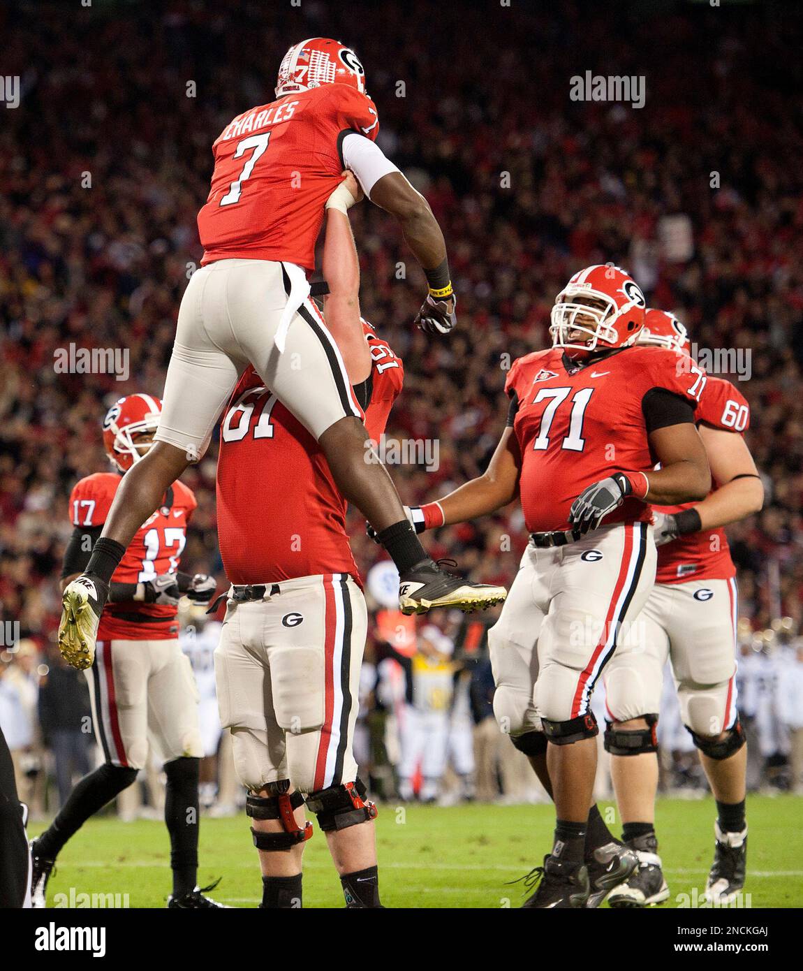 Georgia tight end Orson Charles (7) gets a lift from Georgia center Ben ...