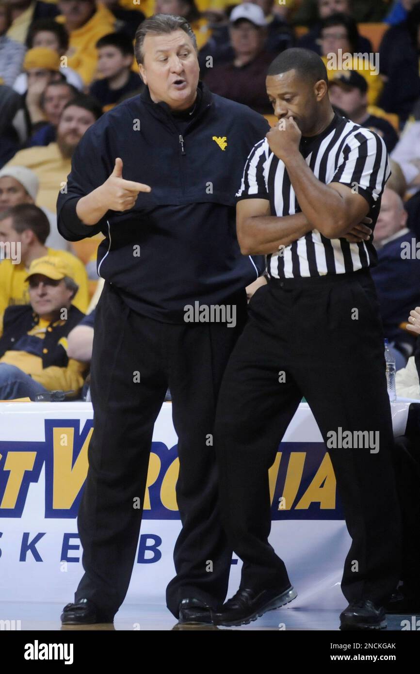 West Virginia's Bob Huggins, left, speaks to an official against VMI ...