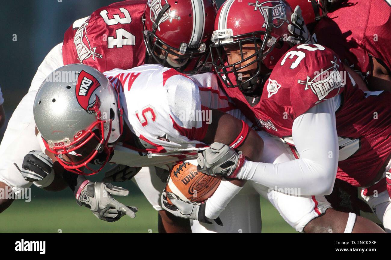Western Kentucky running back Antonio Andrews (5) is stopped by Troy ...