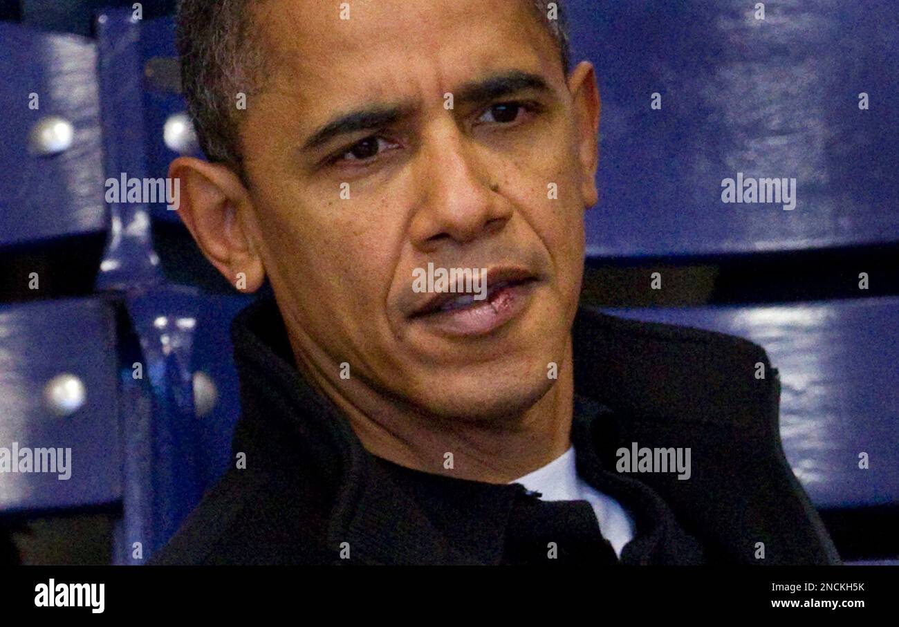 President Barack Obama looks on during an NCAA basketball game between ...
