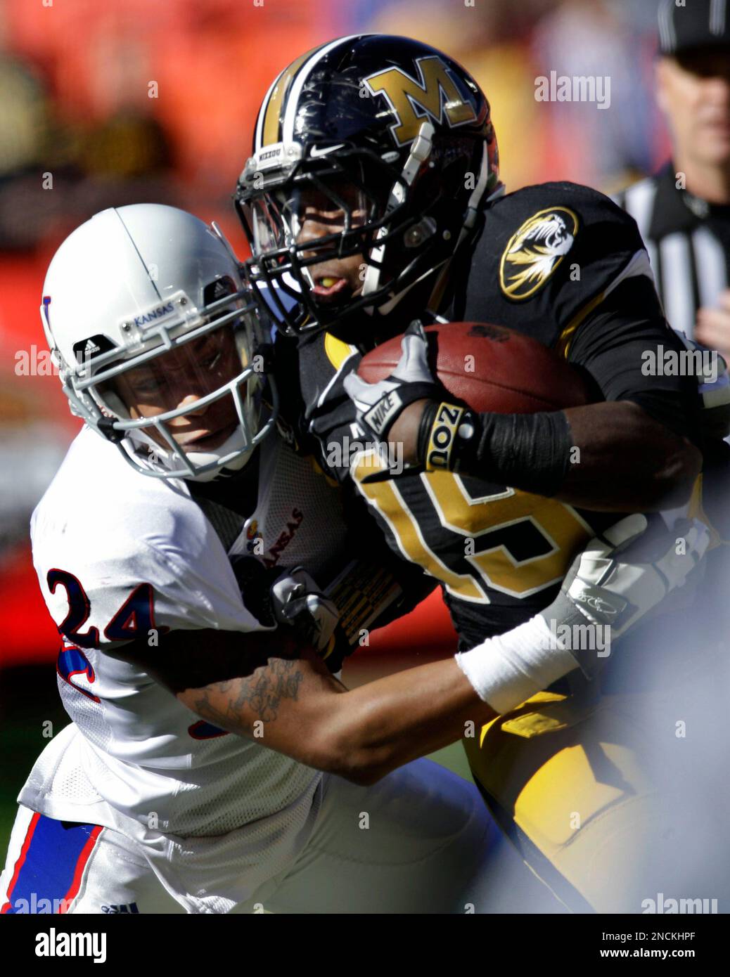 Missouri kick returner Carl Gettis (19) is tackled by Kansas defender ...