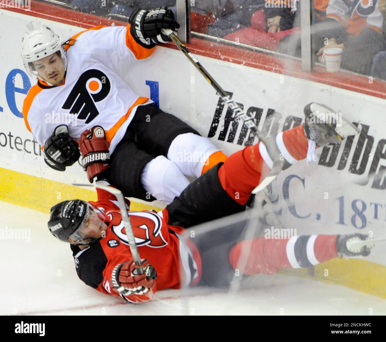 New Jersey Devils' Colin White hits the ice after being tripped by ...