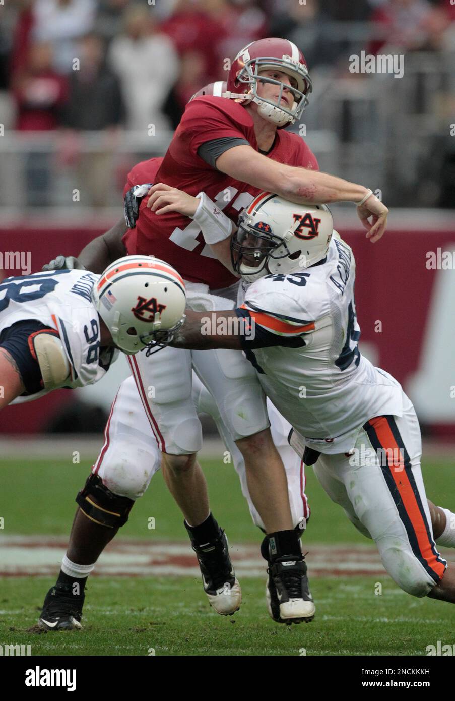 Alabama quarterback Greg McElroy (12) is pinched by Auburn defenders ...