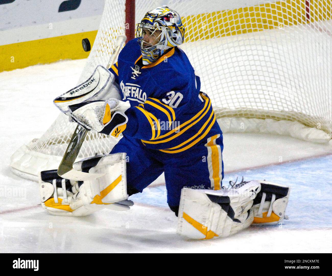 Buffalo Sabres goalie Ryan Miller reaches for a loose puck after making ...