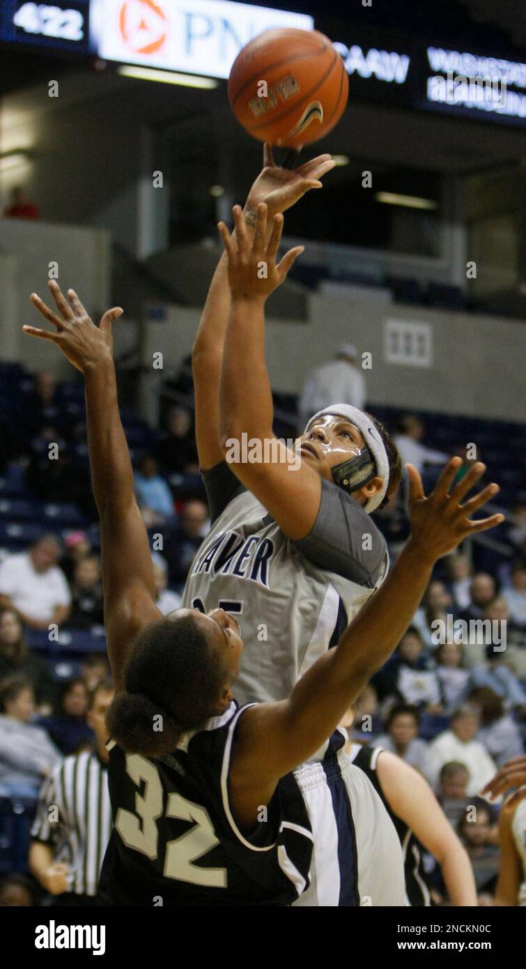 Xavier forward Amber Gray, top, goes up for a shot against Troy forward ...
