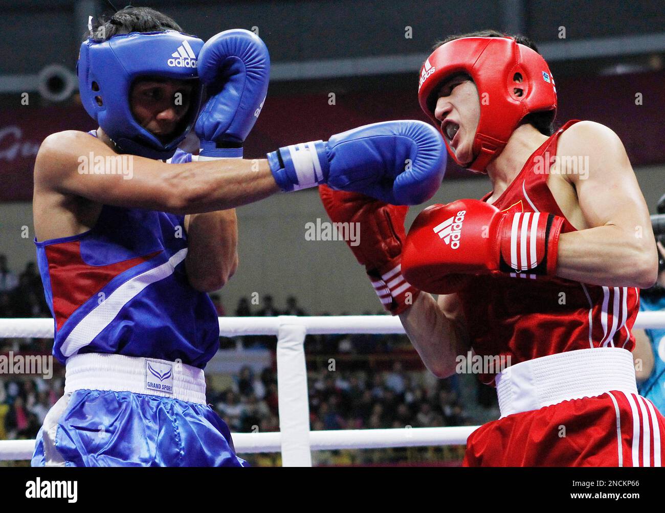 China's Dong Cheng, right, competes with Thailand's Tassamale Thongjan ...