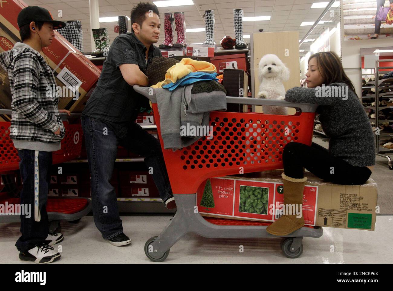 Candy Ho, right, waits in line with Ivan Cheung, second from left, and ...