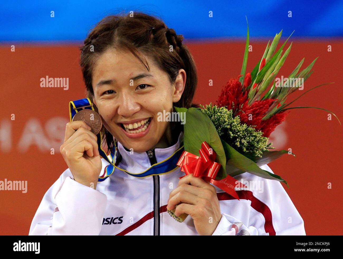 Kyoko Hamaguchi of Japan holds her bronze medal after the award ...