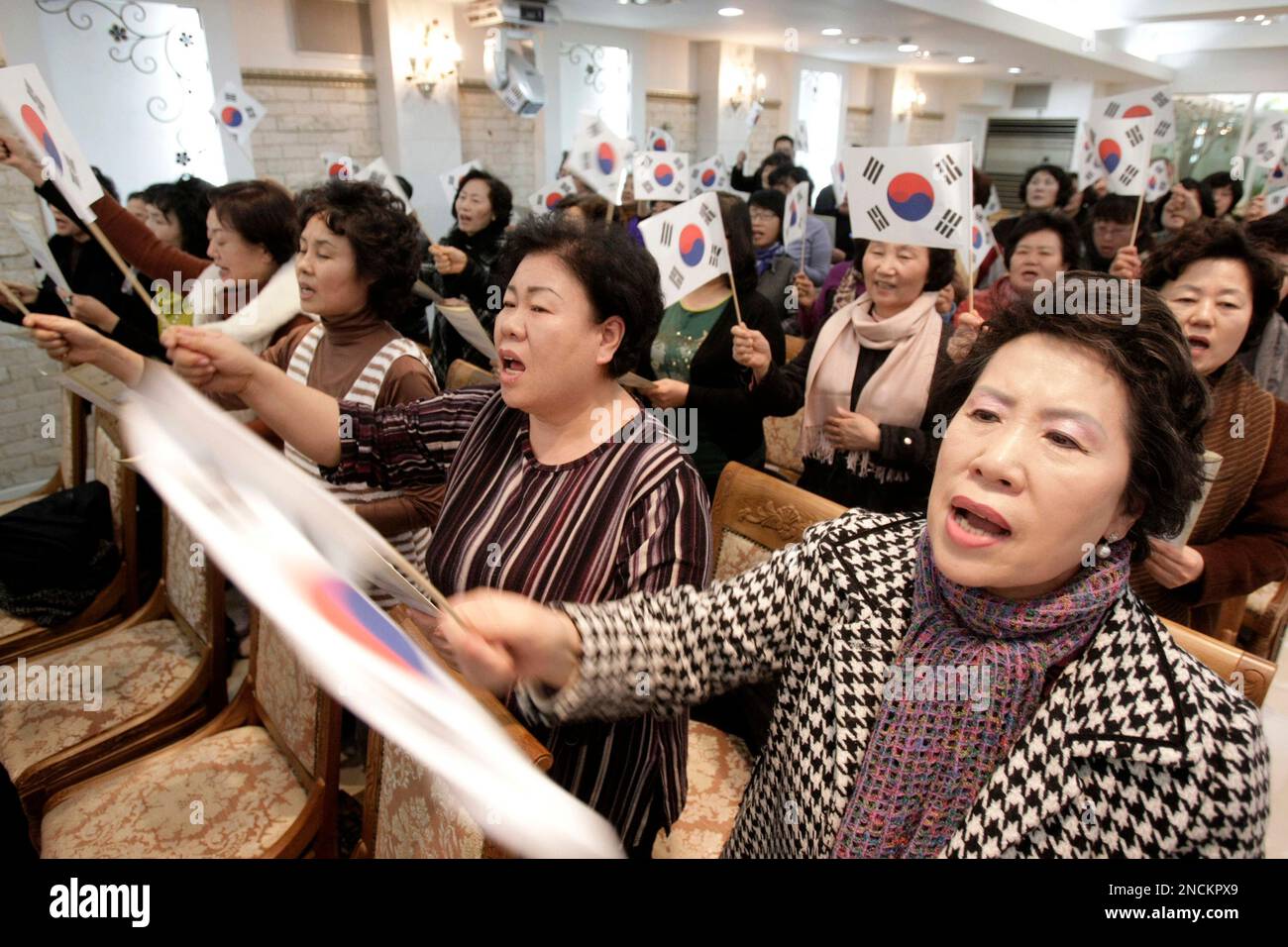 South Korean Christians women wave national flags and shout slogans ...