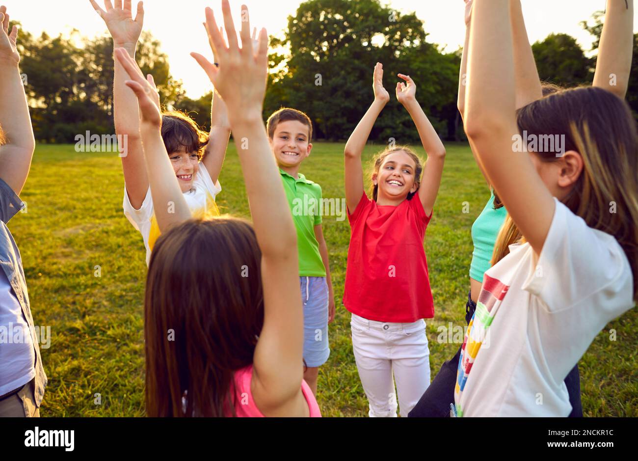Group of happy, cheerful children playing in the park and having fun ...