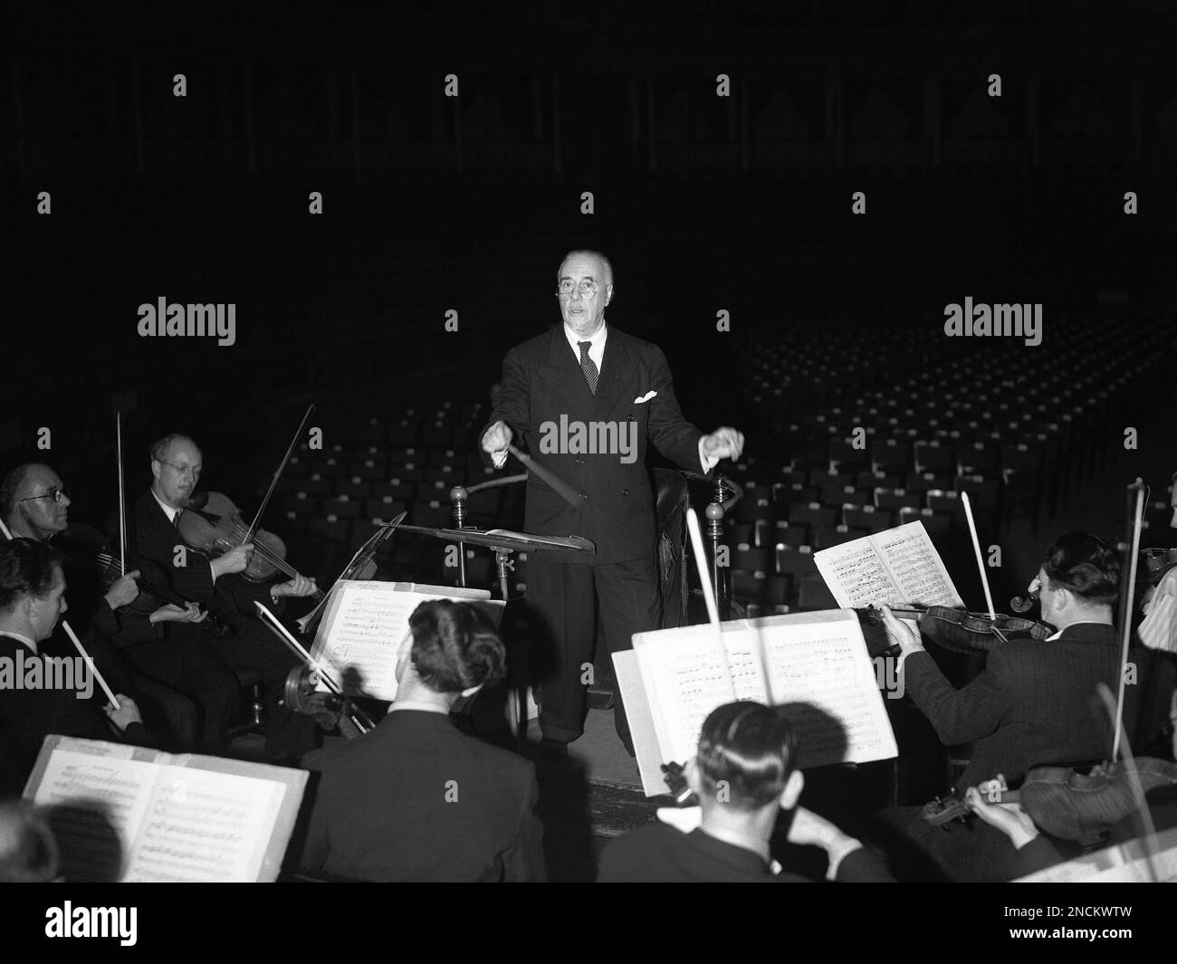 English conductor Sir Thomas Beecham conducts the Royal Philharmonic ...