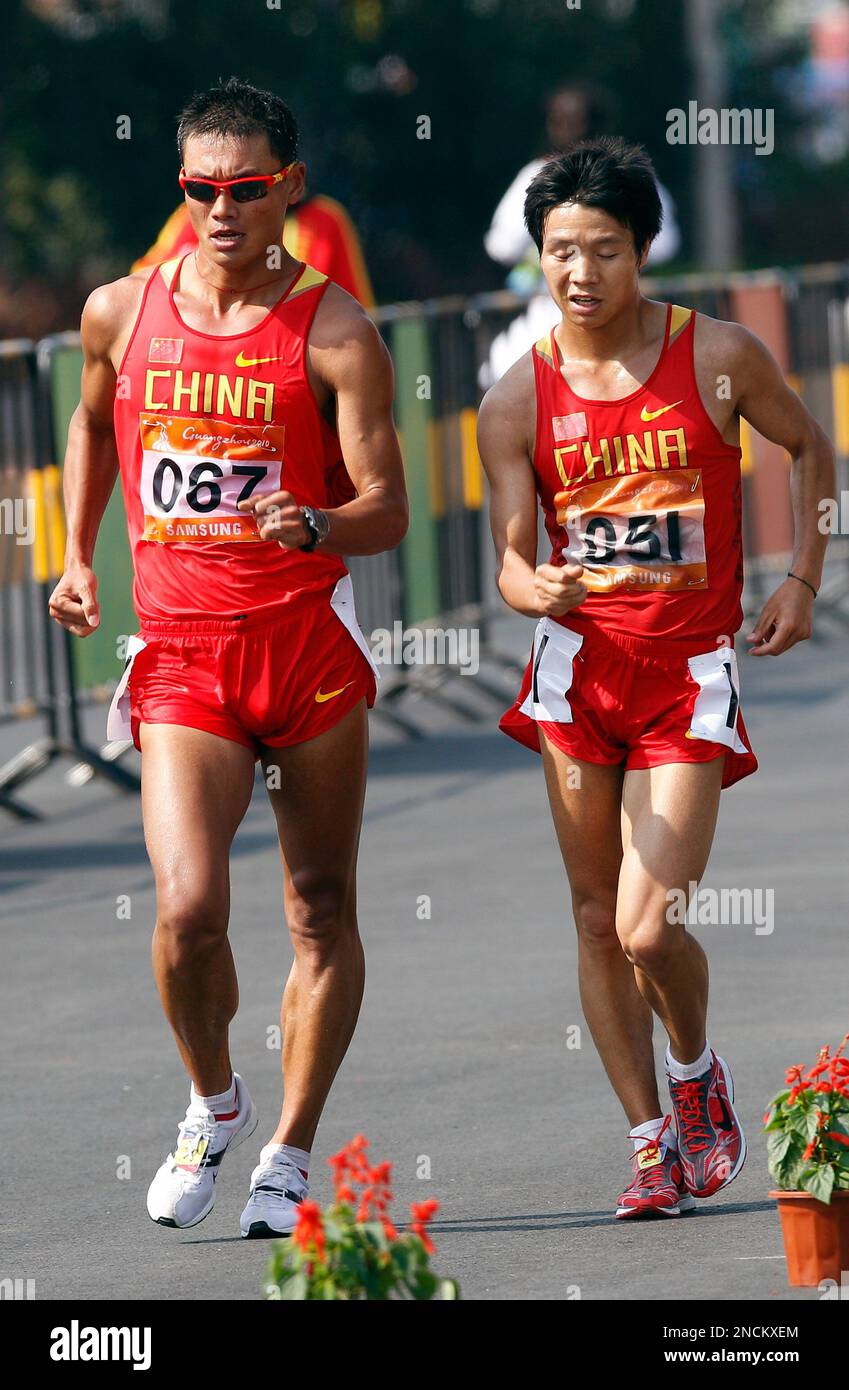 China's Si Tianfeng, left, winner of the gold medal, leads silver medal ...
